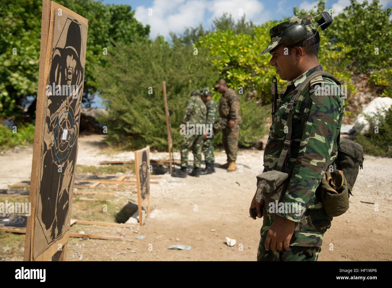 A Maldives National Defense Force (MNDF) service member checks his ...