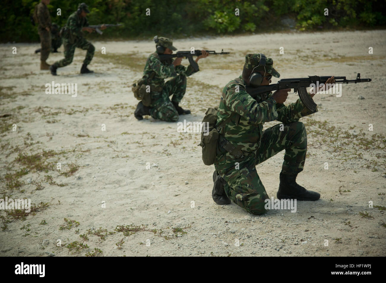 Maldives National Defense Force (MNDF) service members fire rifles ...