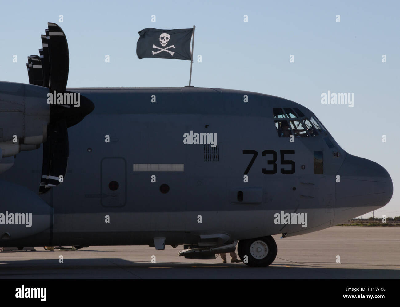 A squadron flag waves on top of a KC-130J Super Hercules with Marine ...