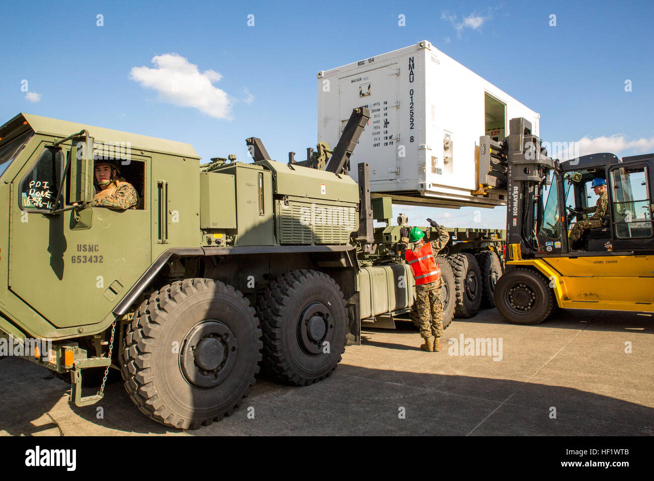 Heavy equipment operators from Marine Wing Support Squadron 171 load a ...