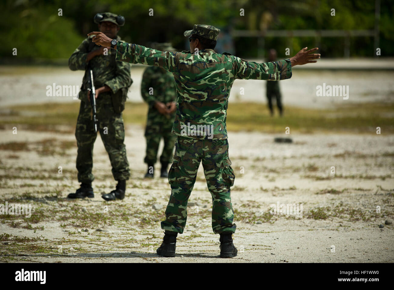 A Maldives National Defense Force (MNDF) service member gives ...