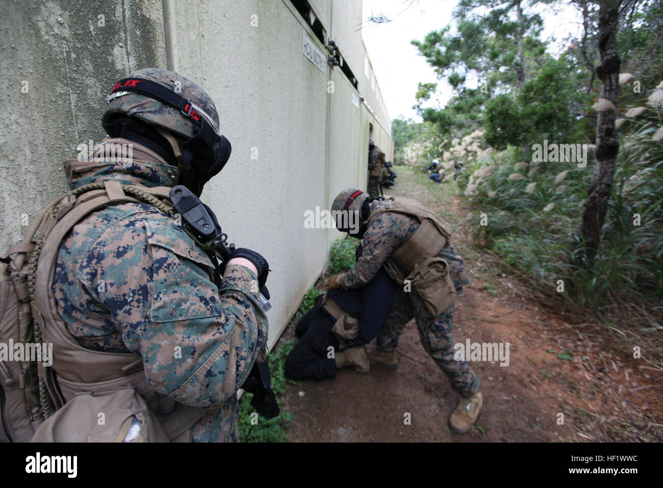 A Marine with 3rd LE Bn. searches and secures a simulated enemy ...