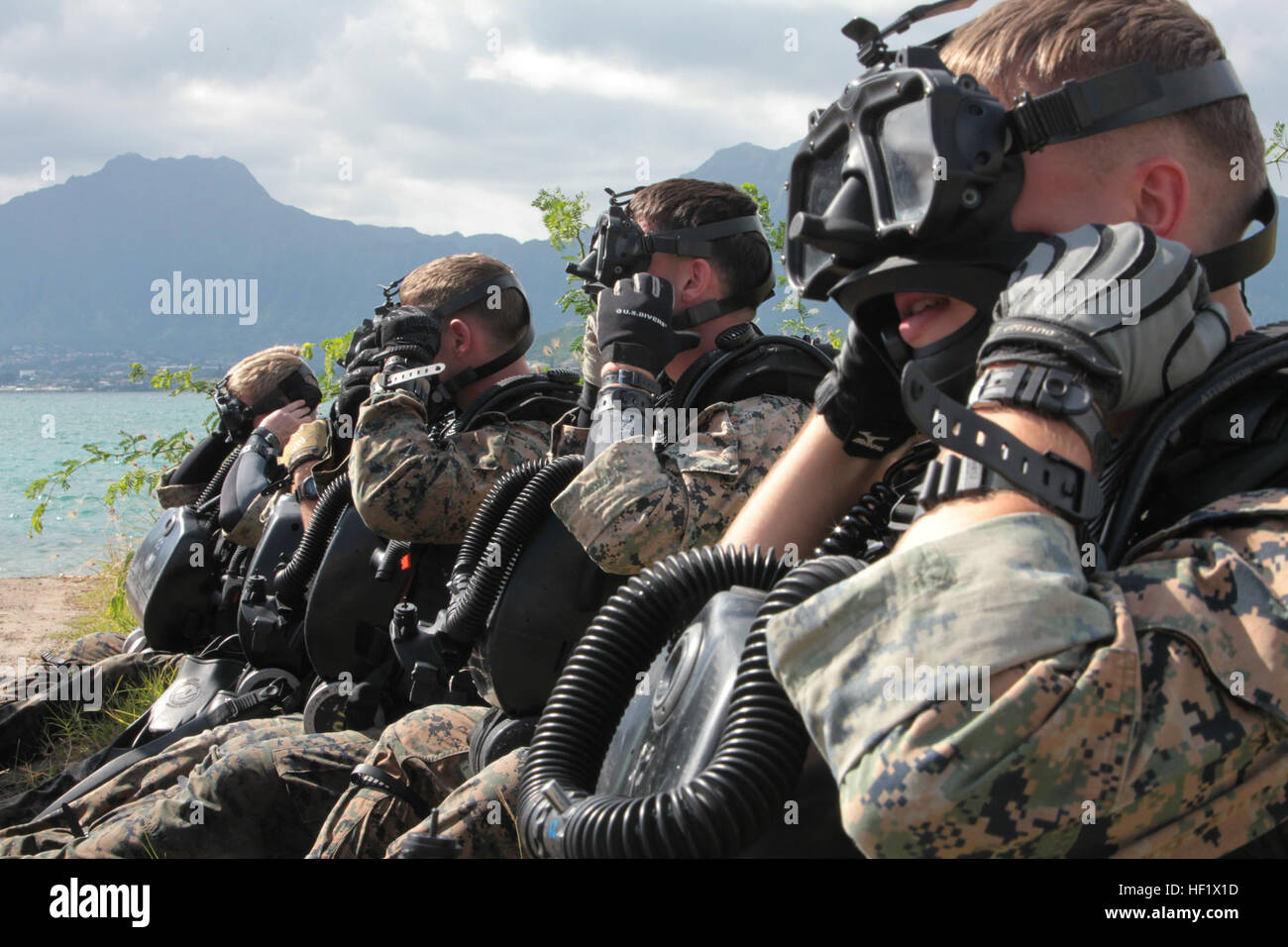 Marines prepare their diving equipment prior to entering the water with ...