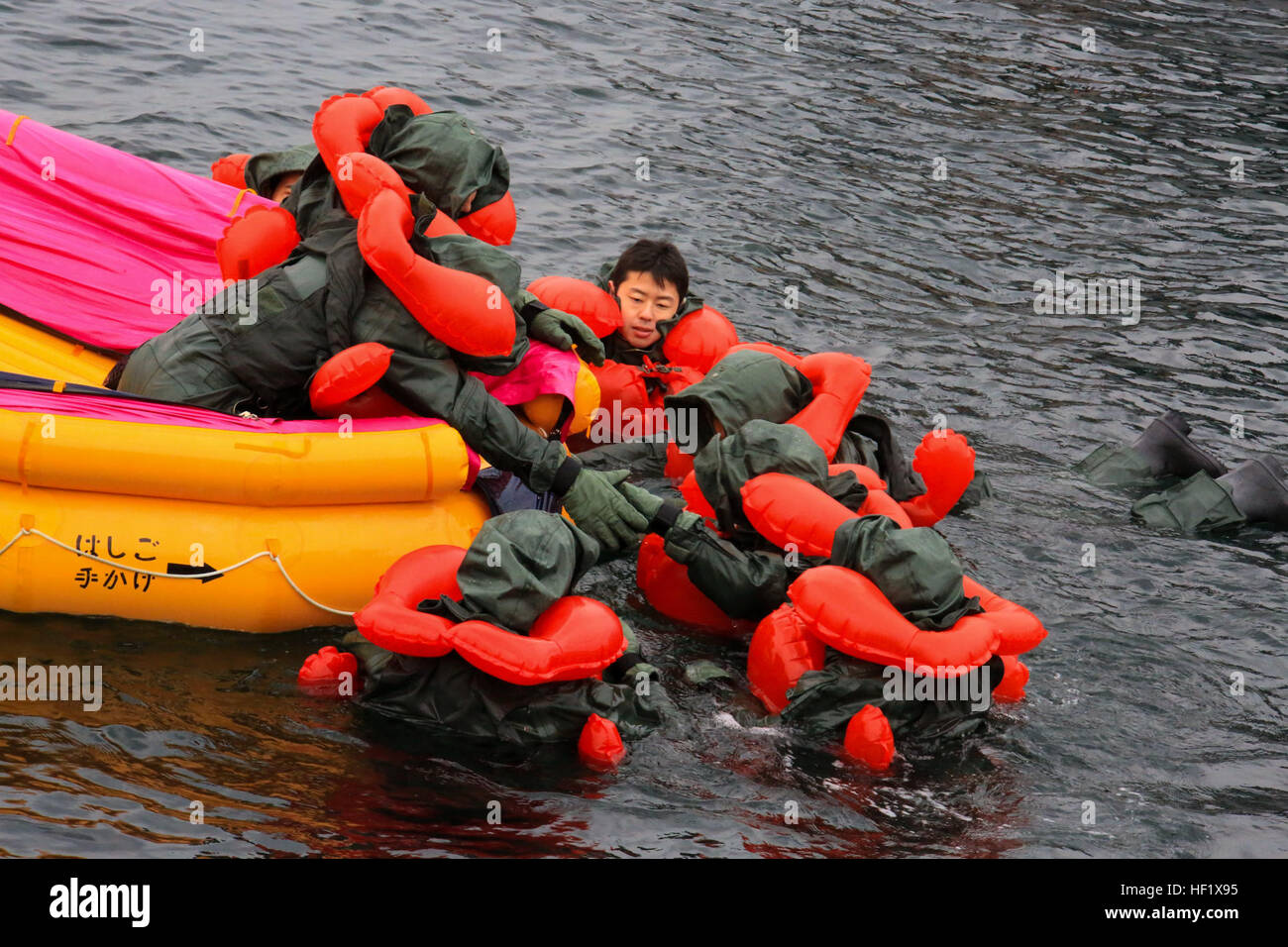 Japan Maritime Self-Defense Force aviators assist each other in ...