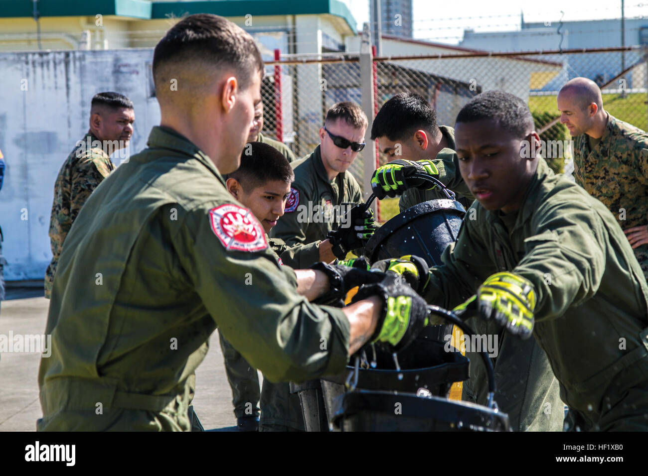Marines pass buckets of water during the bucket brigade event Jan. 31 ...