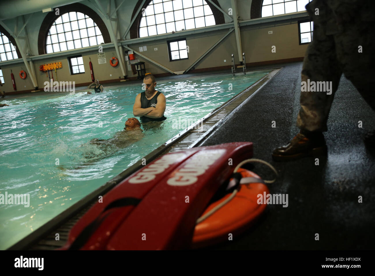 Sgt. Michael Ludwig, a swim instructor, guides Rct. Oscar Rodriguez ...
