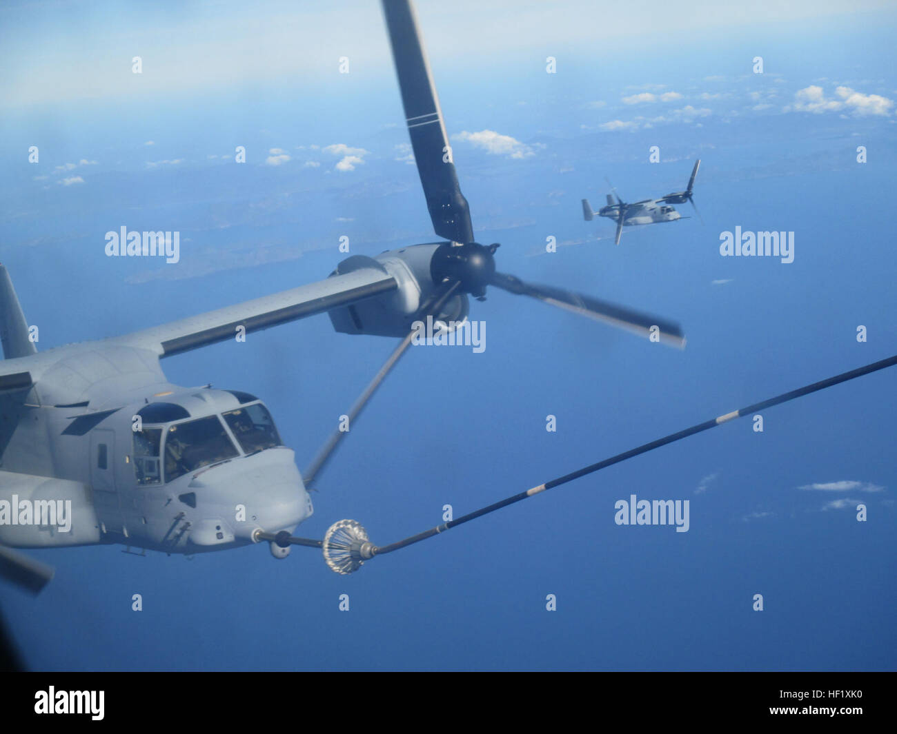 An MV-22B Osprey with Marine Medium Tiltrotor Squadron 262, refuels in mid-air from a KC-130J ...