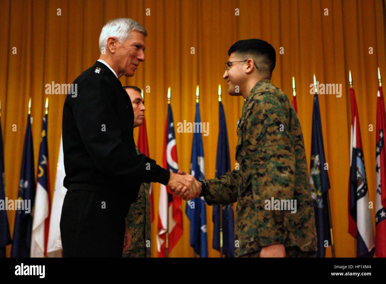 Petty Officer 3rd Class Daniel Vilchezarrona, right, shakes hands with ...