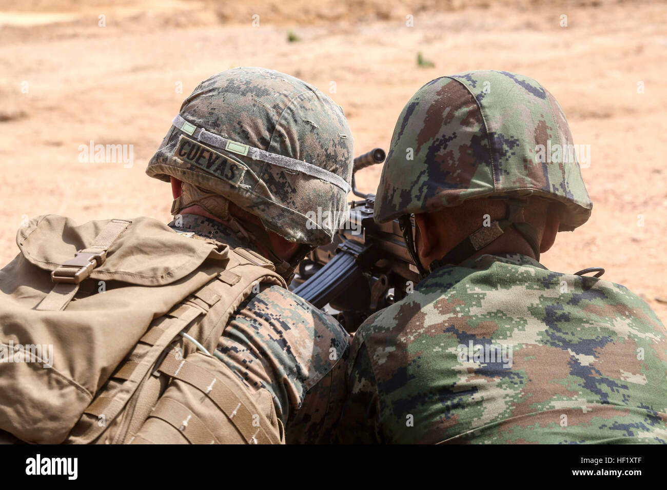 U.S. Marine Lance Corporal Cuevas acts as an assistant gunner for a ...