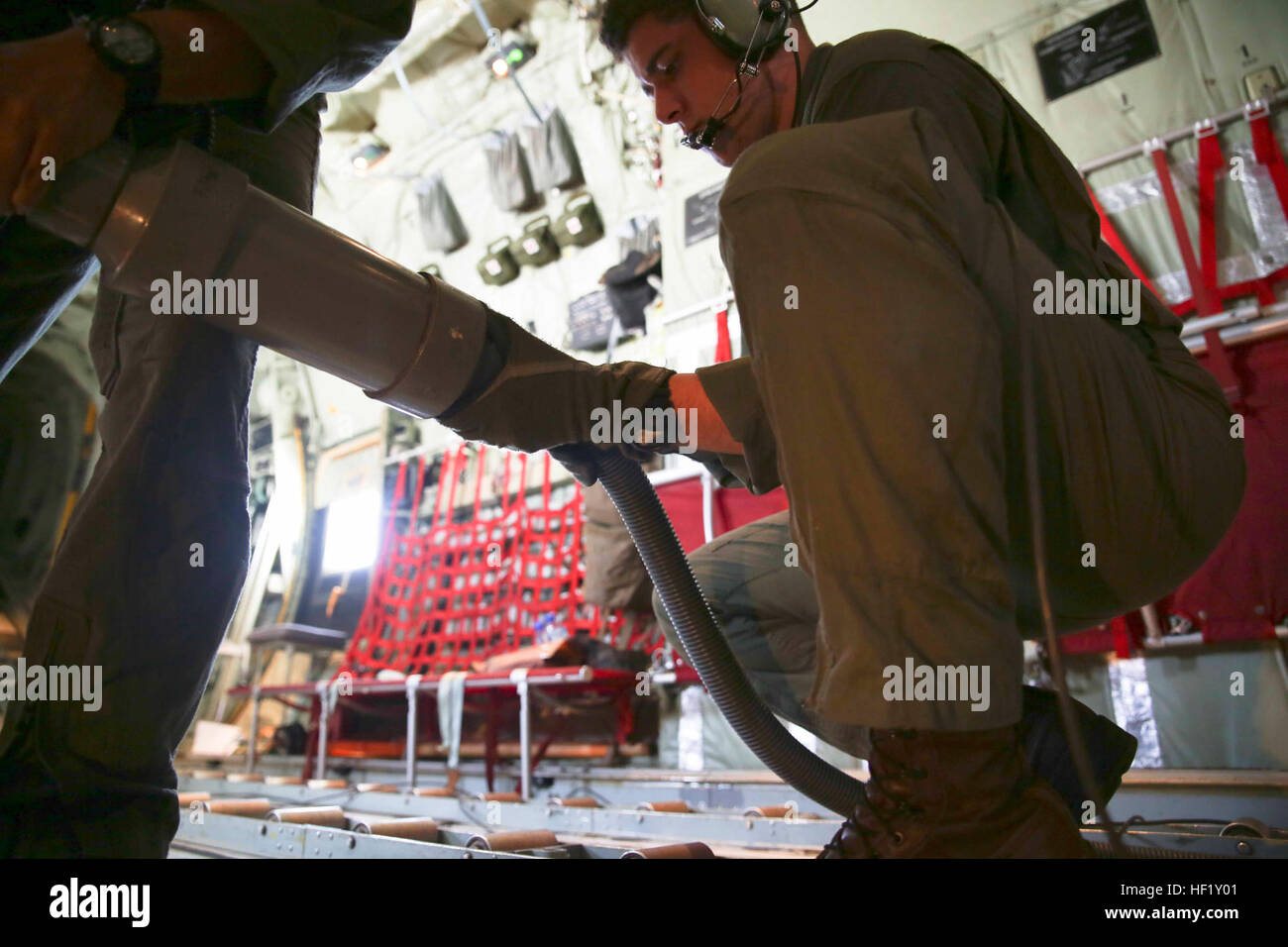 U.S. Marine Cpl. Steven Clayton connects a vaccum together while on a ...