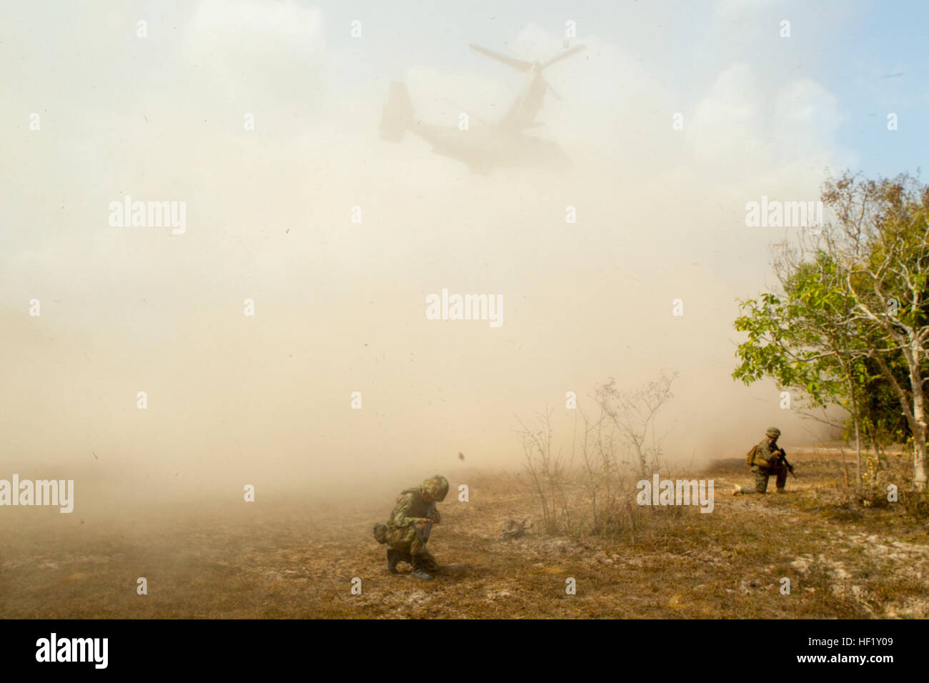 A Royal Thai Marine and a U.S. Marine shield themselves from the rotor ...
