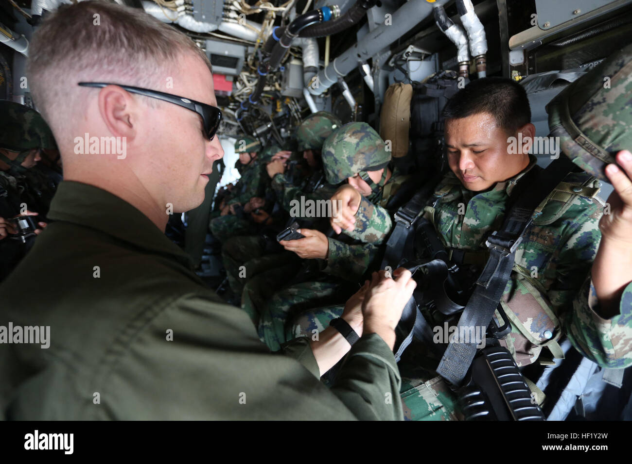 U.S. Marine Capt. Cory Frederick assists a Royal Thai Marine on the ...