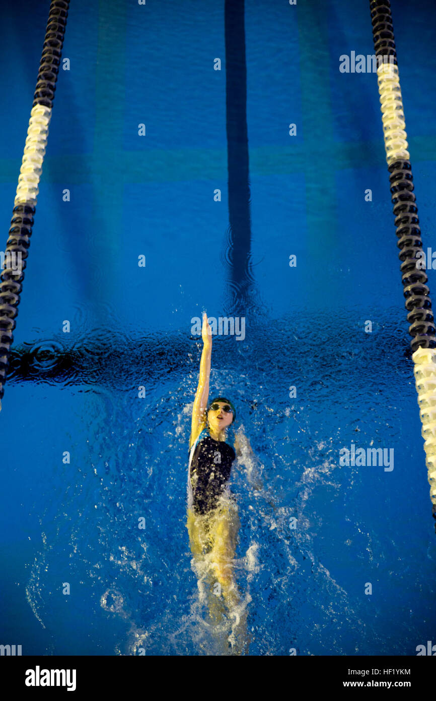 Danielle Piper, 12, swims in a 50-meter back stroke race at a swim meet ...