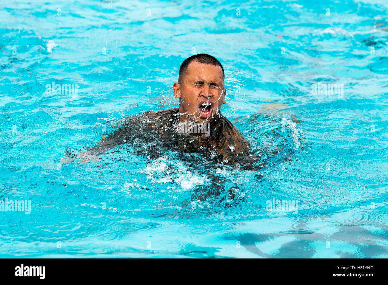 A Marine in Corporals Course conducts a 100-meter swim at the base pool ...