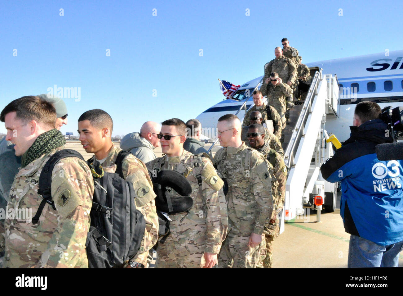 Soldiers with the 198th Expeditionary Signal Battalion exit the plane ...