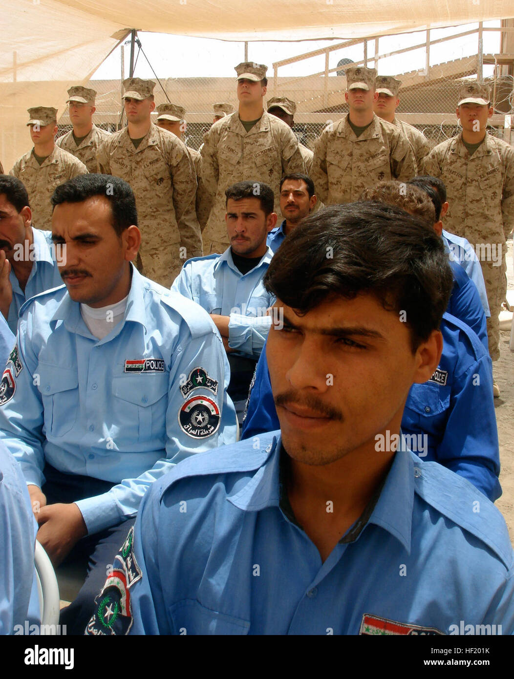 Iraqi police wait to receive their diplomas after attending the first ...