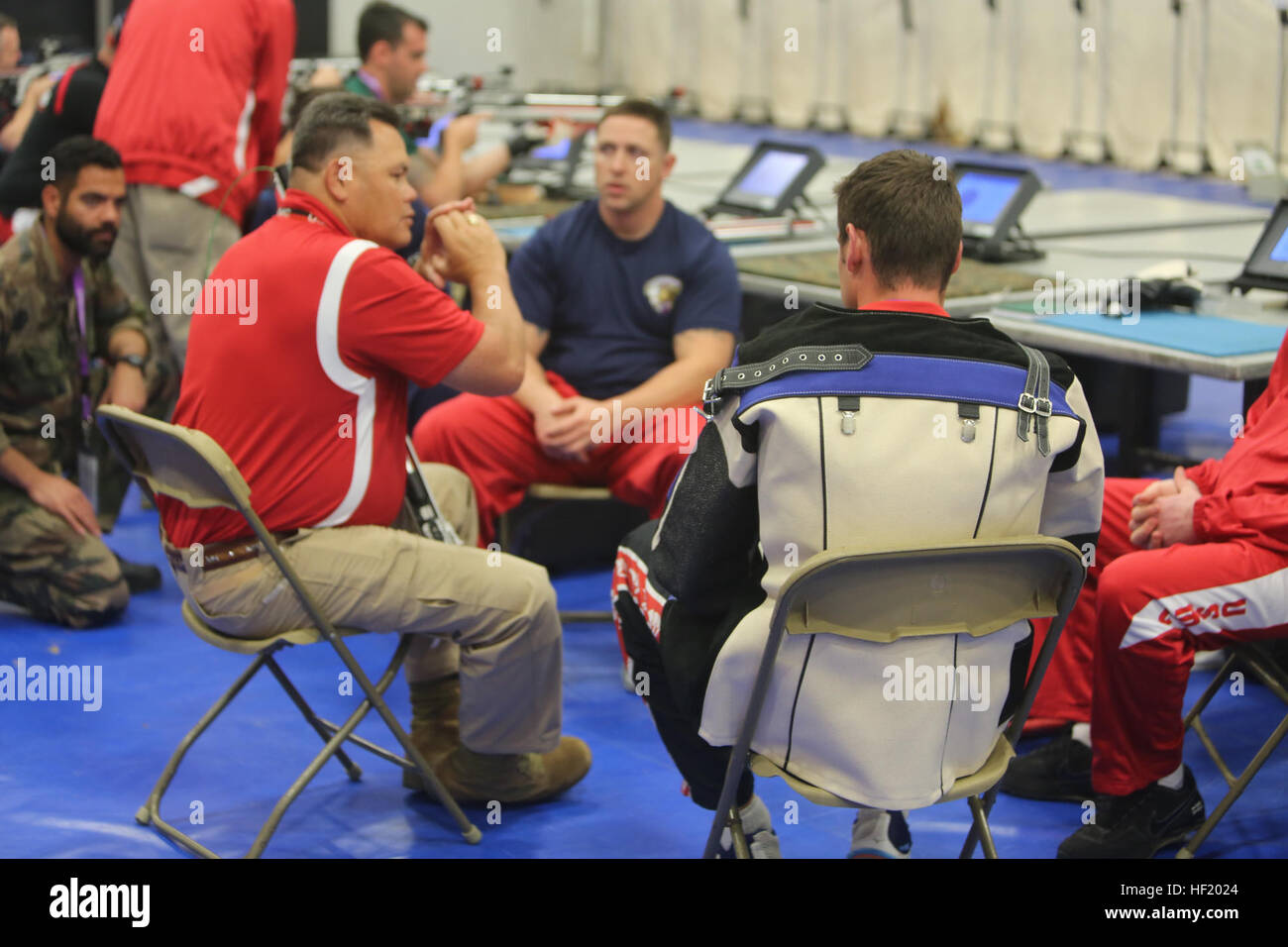 Athletes listen as their coach explains the basics of marksmanship ...