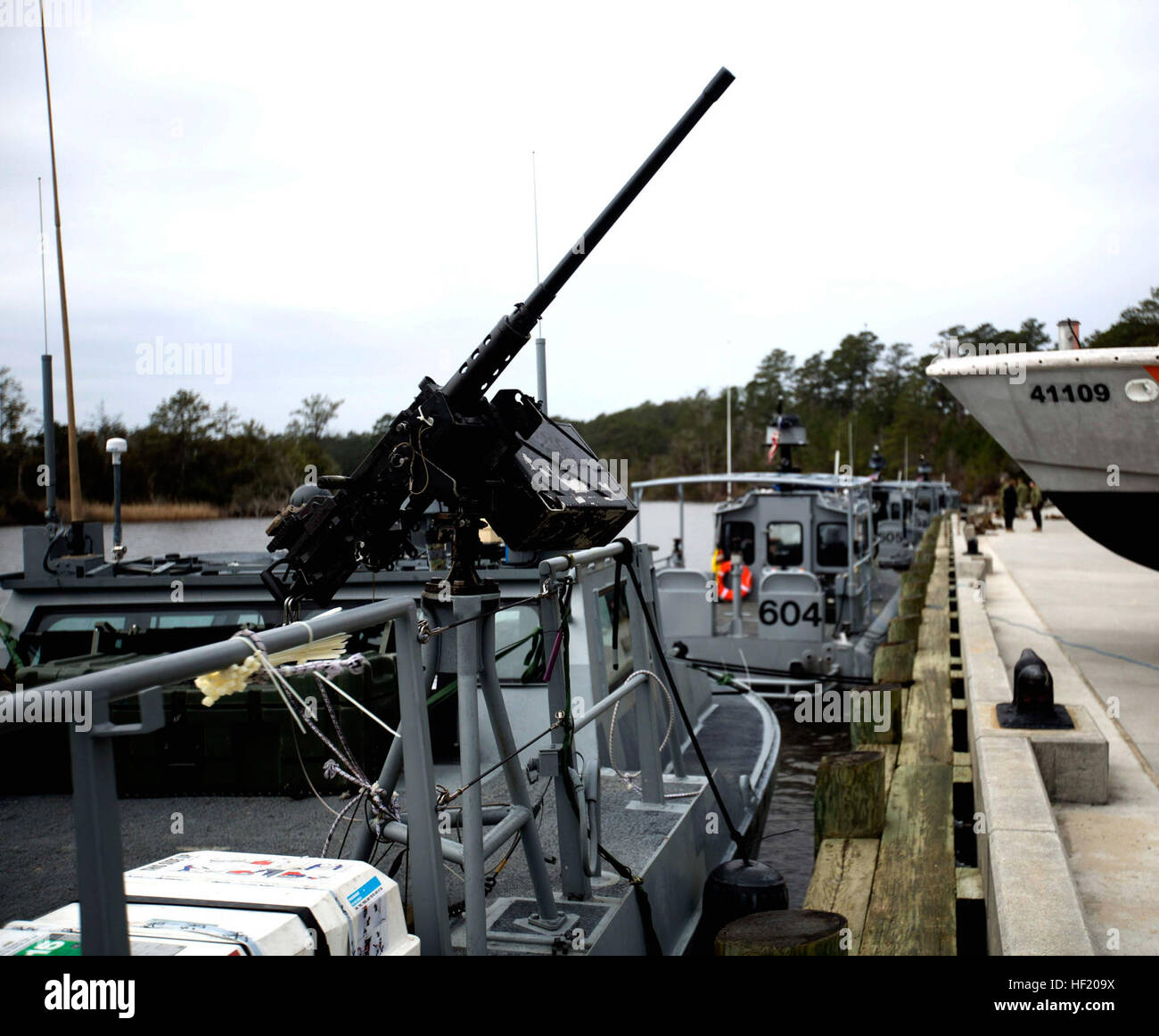 A Browning M2HB .50 caliber machine gun sits on a Riverine Command Boat ...