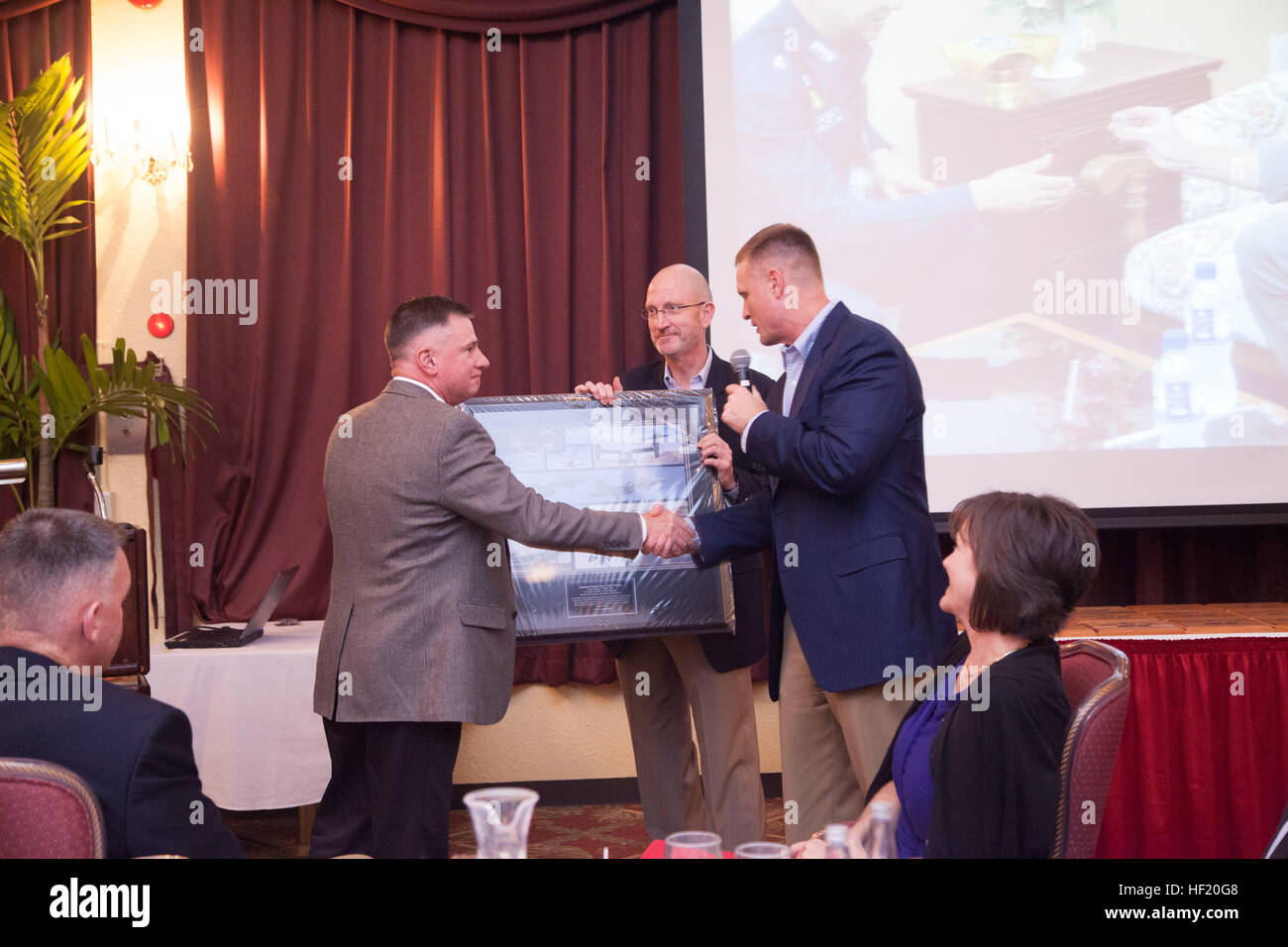 Brig. Gen. Steven R. Rudder, far right, presents a gift to Lt. Gen ...