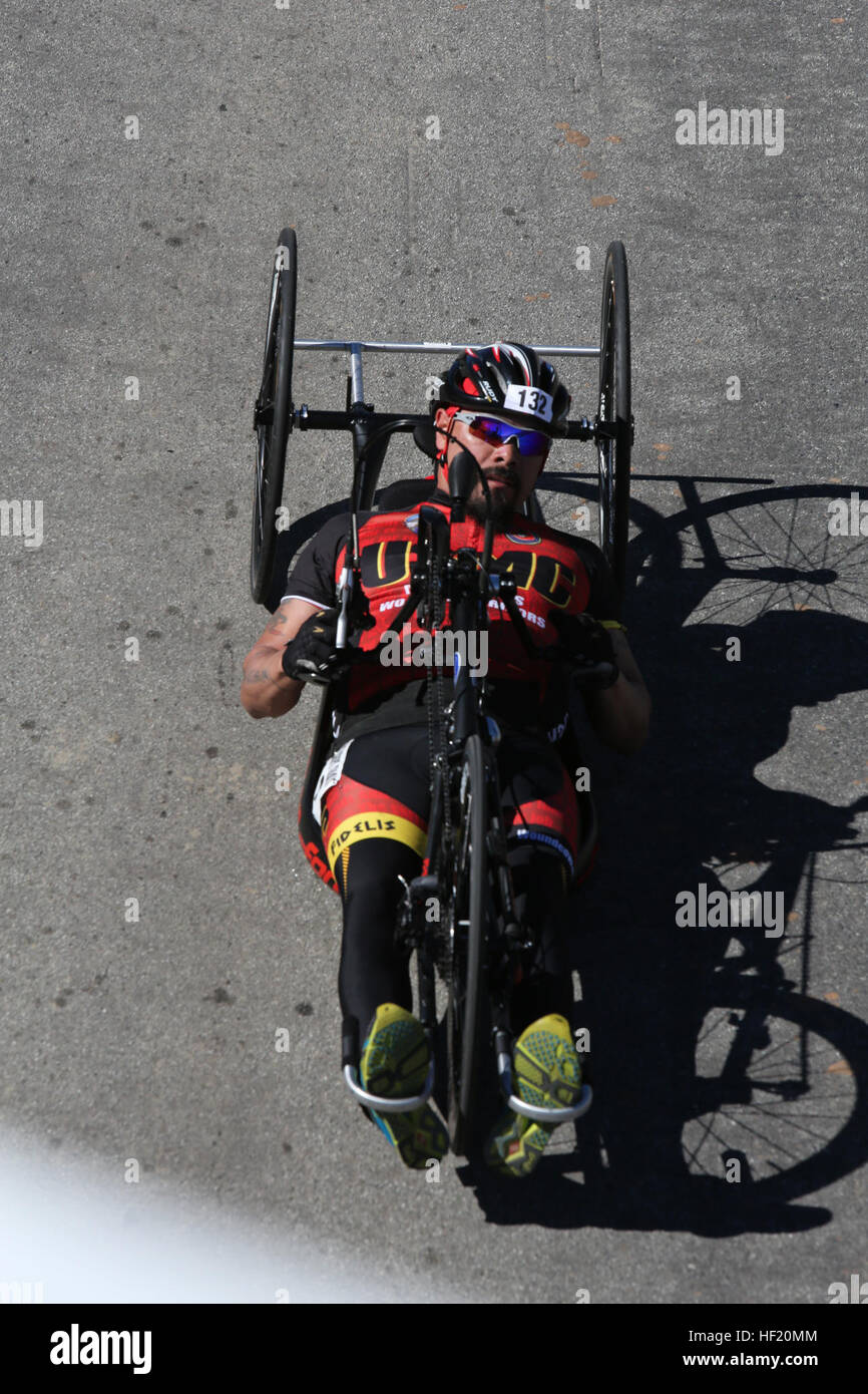 Participants compete in the hand-crank cycling event during the 2014 ...