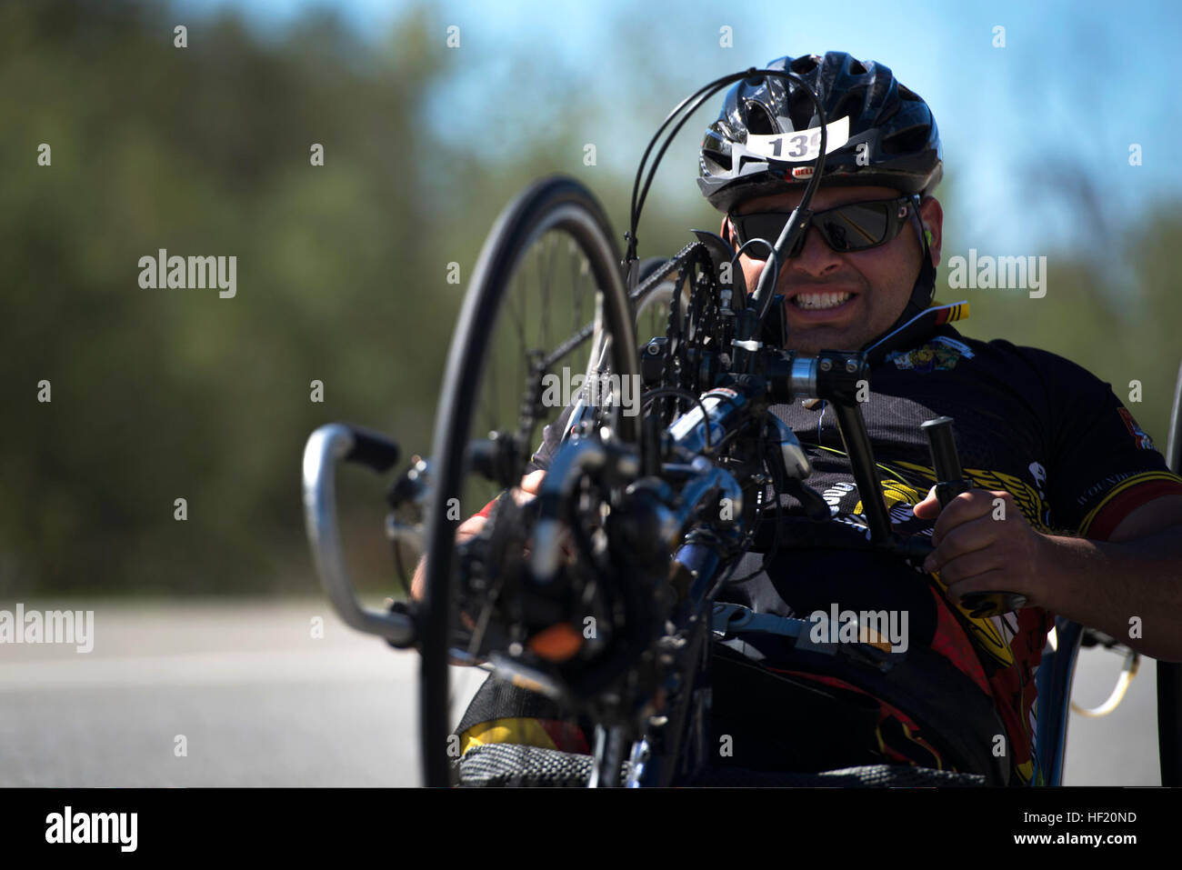 An athlete competes in the recumbent-cycle competition during the 2014 ...