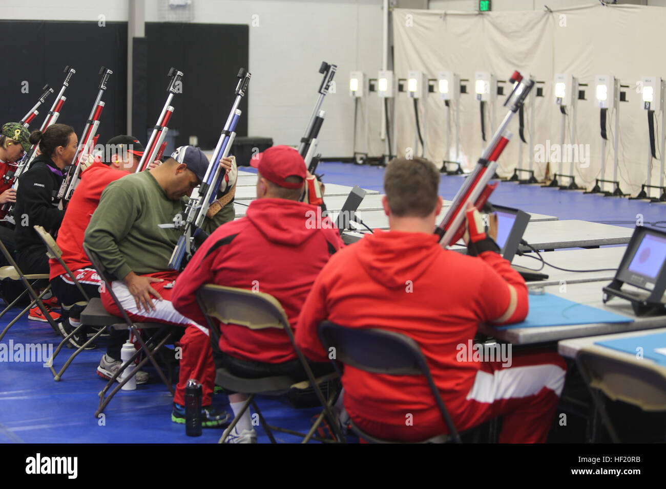 Athletes on the firing line wait for the command to commence fire ...
