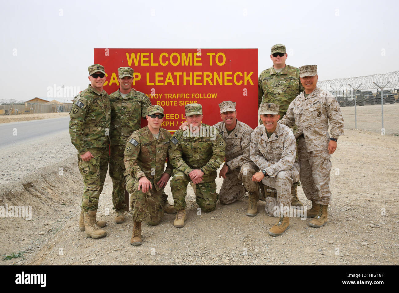 U.S. Military personnel pose in front of the main welcoming sign to ...