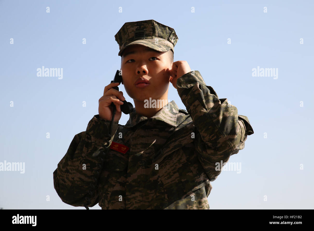 Republic of Korea Marine Cpl. Kim Sang Min performs a radio check while ...