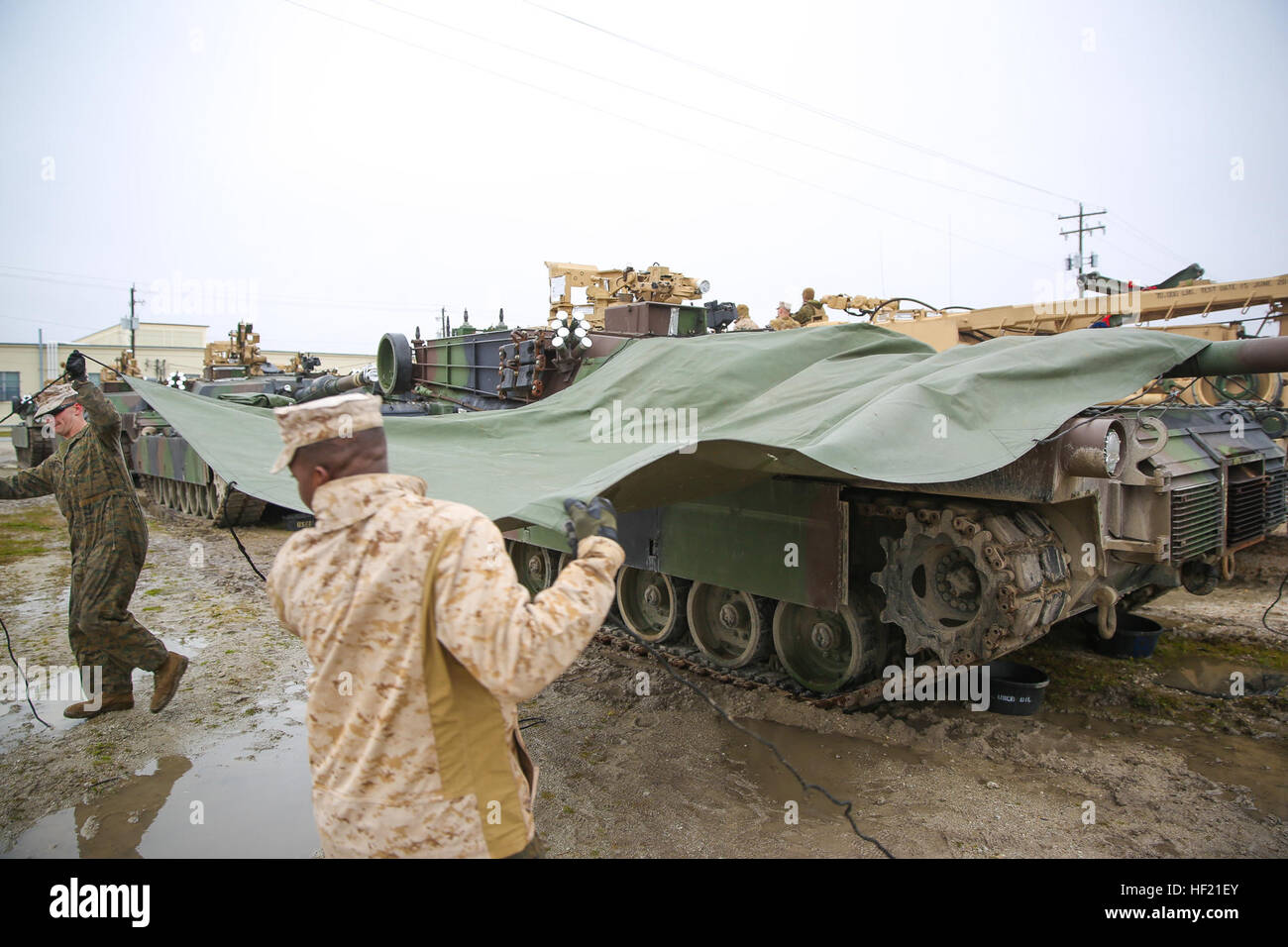 Marines with 2nd Tank Battalion, 2nd Marine Division, pull a tarp off ...