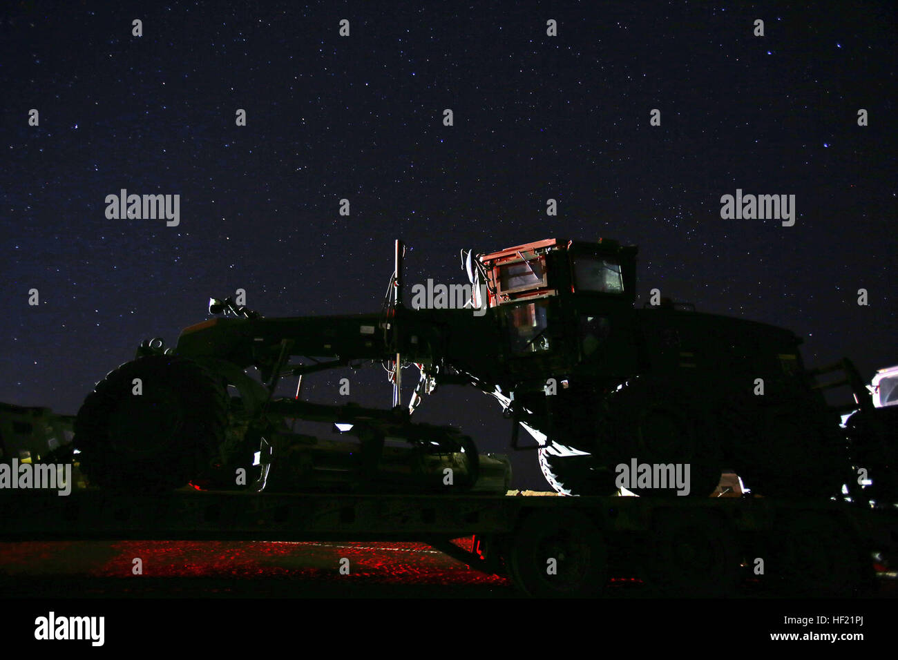 A 120M military motor grader is staged for transportation during the ...