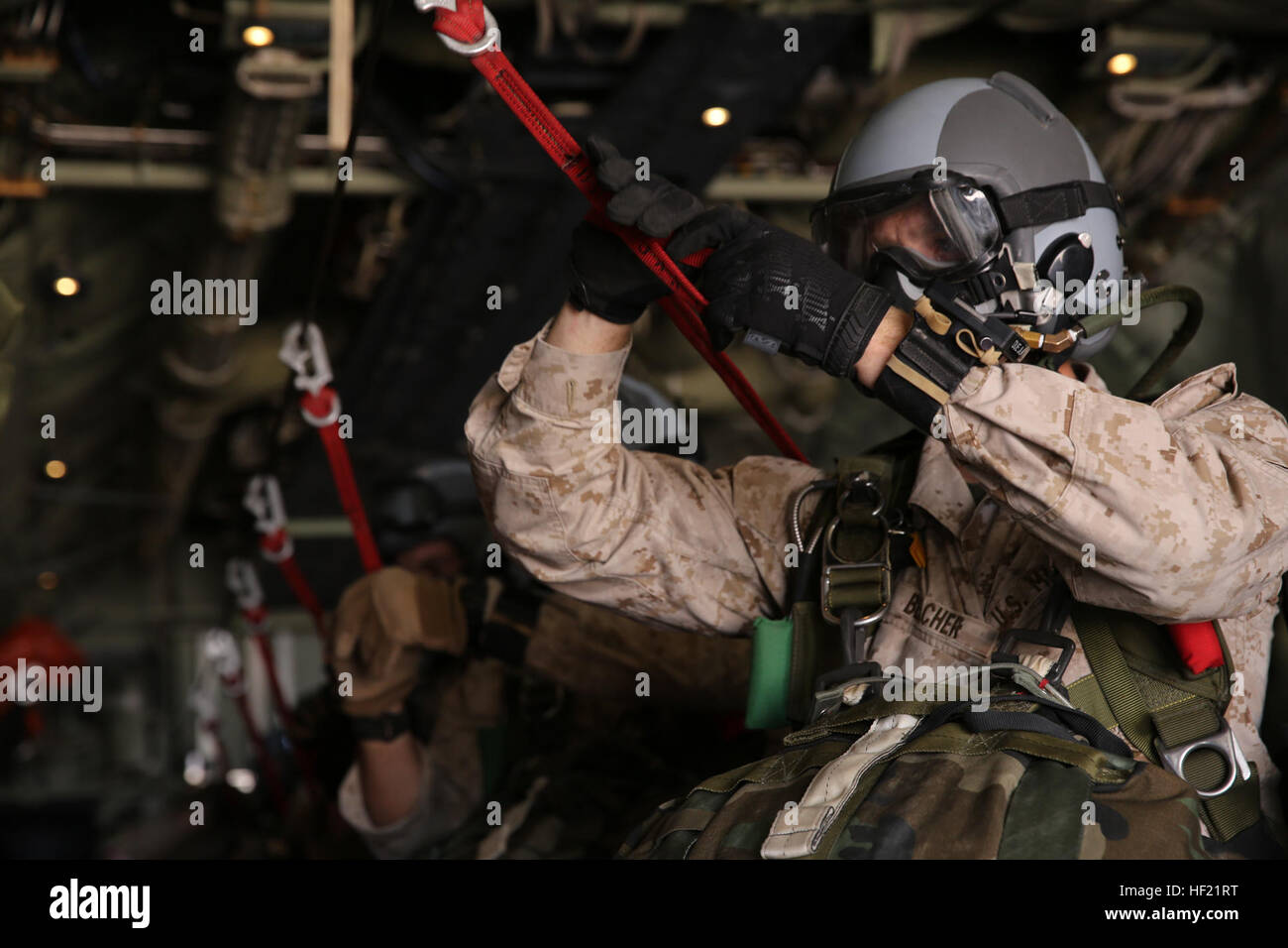 A Marine with Bravo Company, 1st Reconnaissance Battalion, attaches his ...