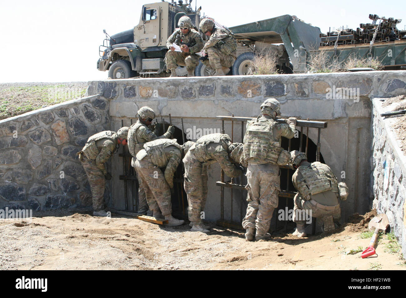U.S. Army soldiers with the 65th Engineer Battalion install culvert ...