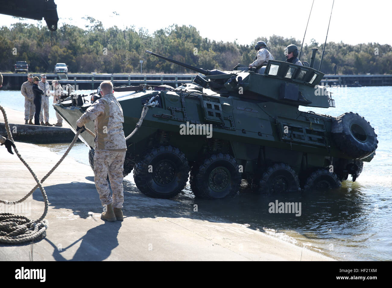 A Marine with 2nd Light Armored Reconnaissance Battalion coils up a ...