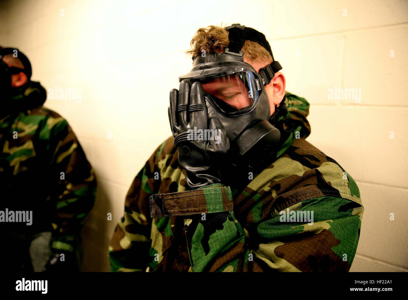 Lance Cpl. Stephen Richardson breaks the seal of his M50 gas mask ...