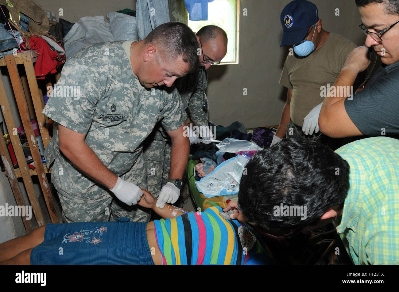 U. S. Army Sgt. 1st Class Noah Cunningham administers an intravenous ...