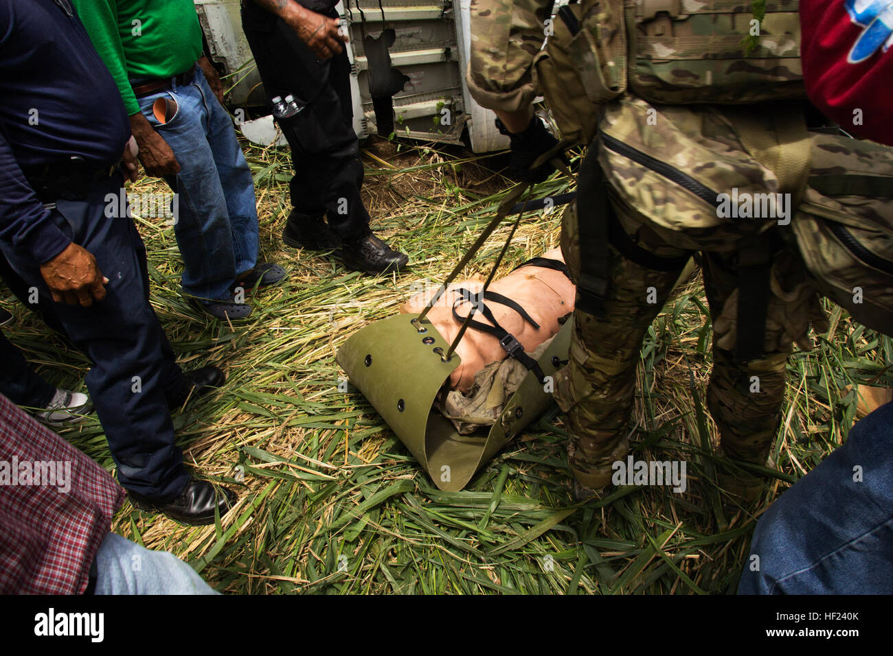 A crowd of villagers surround a "survivor" of a downed aircraft as an ...