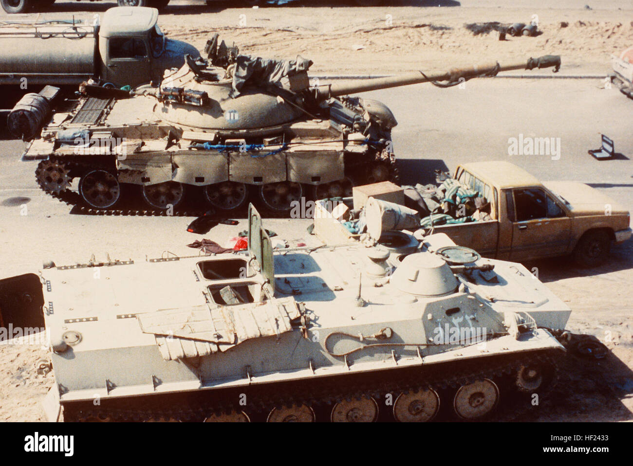 An MT-LB multipurpose tracked vehicle, foreground, and a T-62M main ...