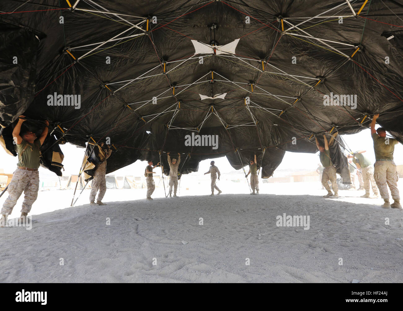 U.S. Marines with Headquarters Regiment, 1st Marine Logistics lift up a ...