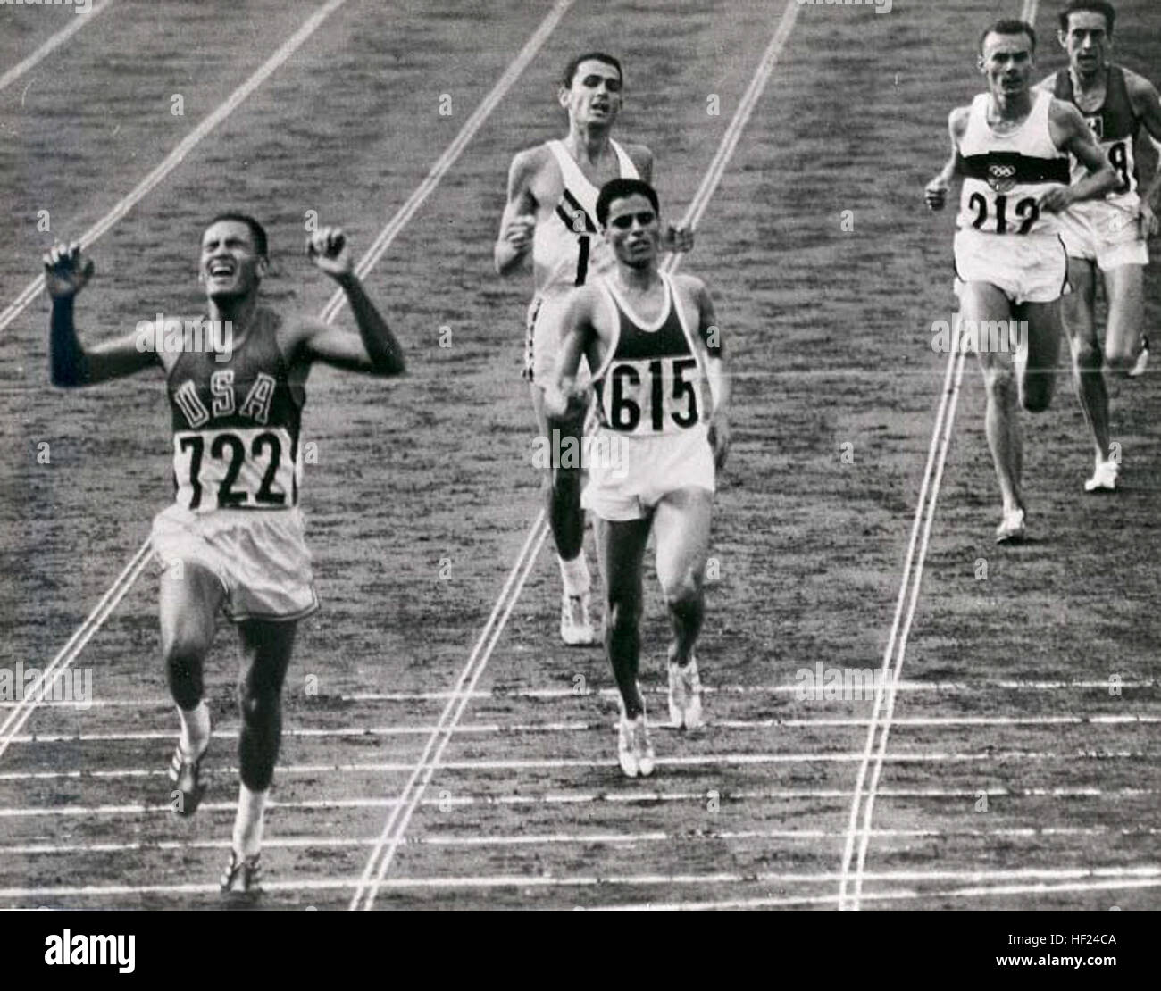 Athlete Billy Mills crosses the finish line to win the 10,000 meters at ...