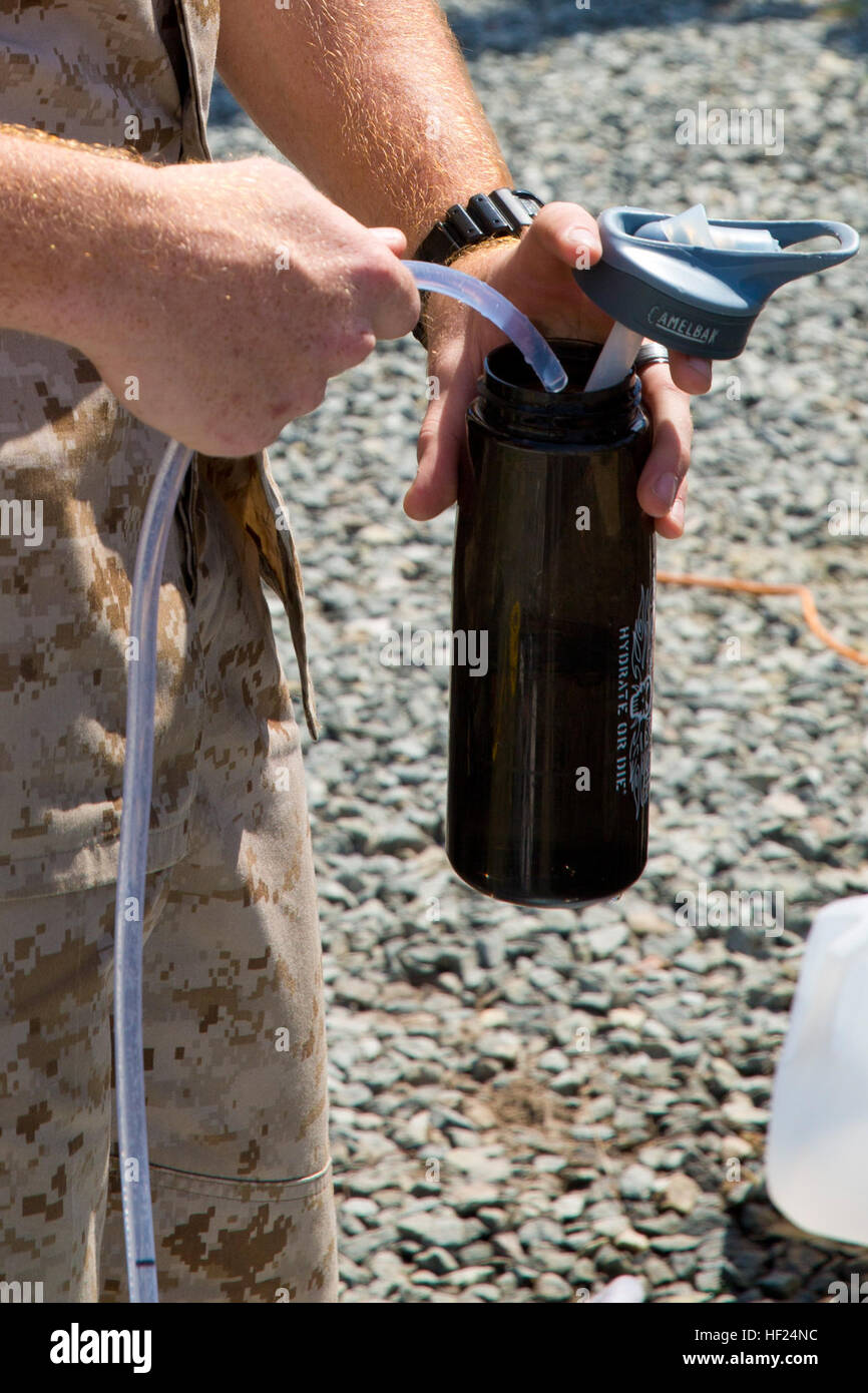 A Marine tests water filtered through the small unit water purification ...