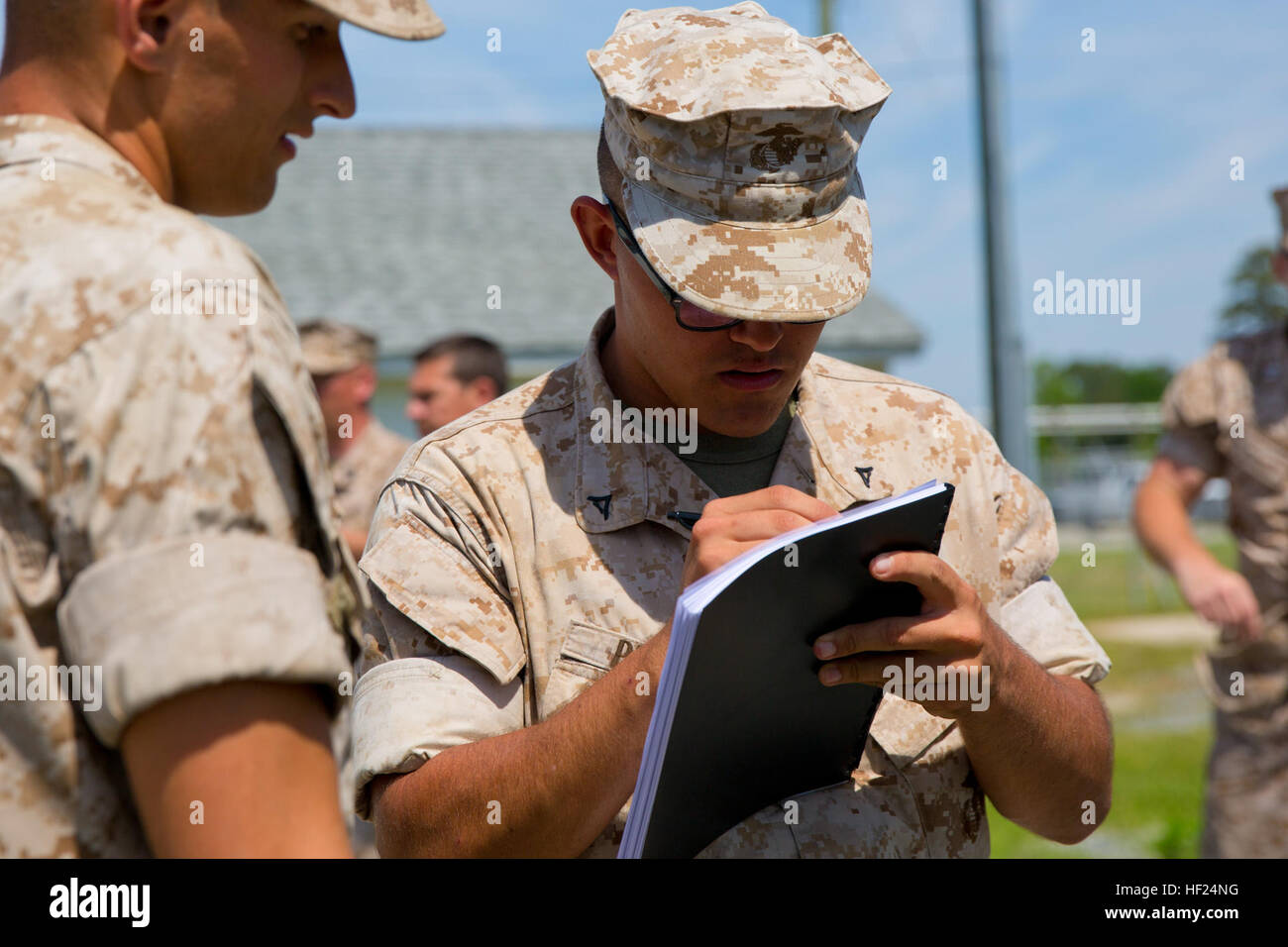 A Marine with 2nd Marine Logistics Group completes a report after ...