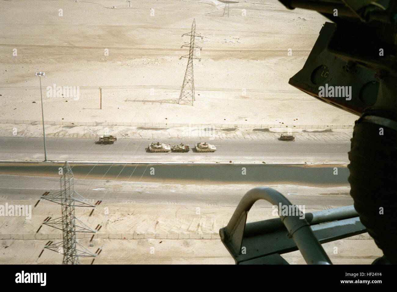 Allied armored vehicles remove an Iraqi tank from the road during ...
