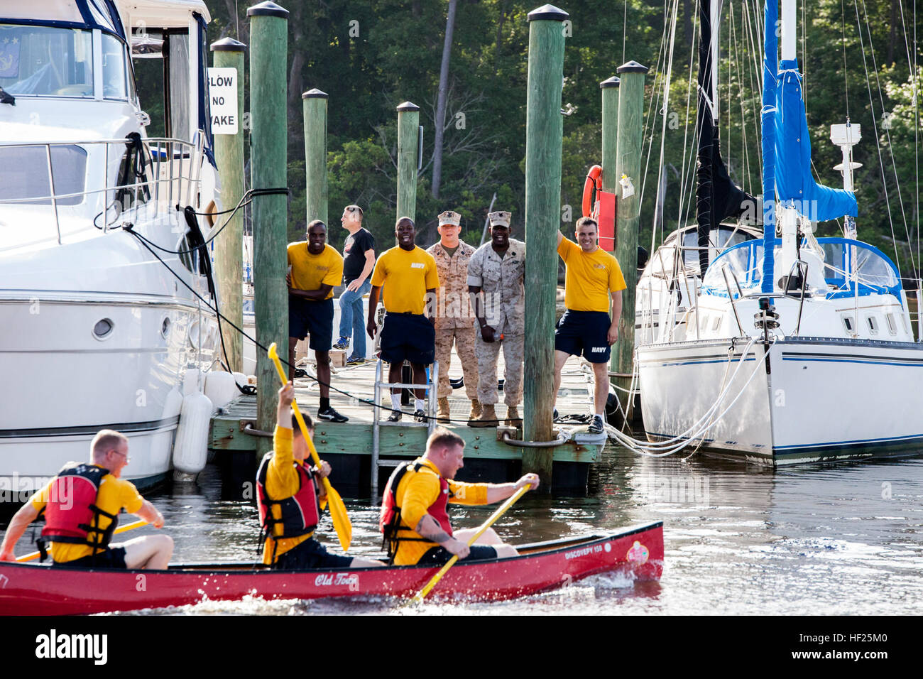 Navy sailors motivate each other in the canoe race at the Gotschalk ...