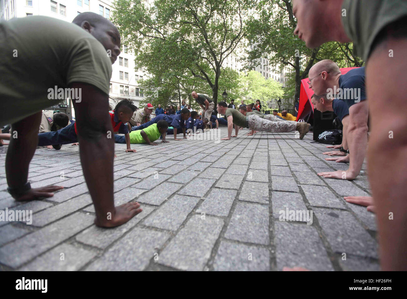 Boy scouts execute push-ups during a physical fitness session ran by U ...