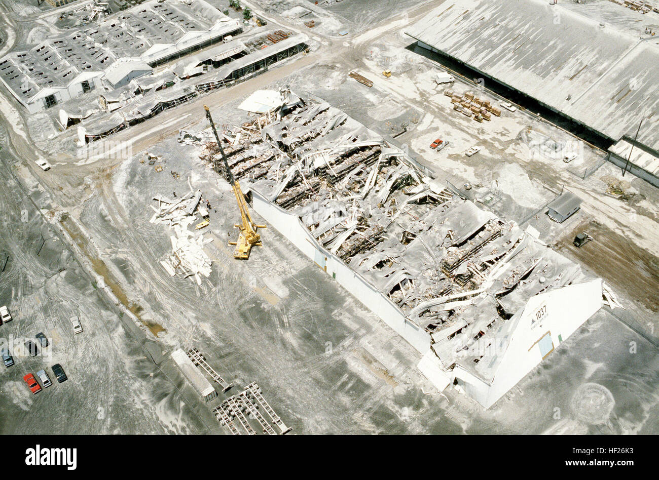 A building lies in ruins under the weight of ash from the eruption of ...