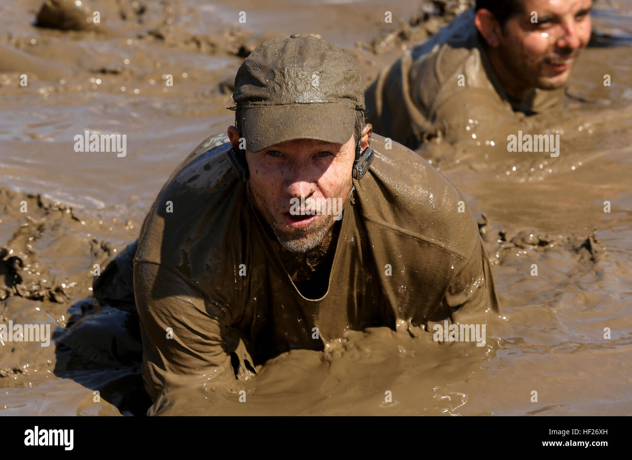 A participant swims through a mud pit during the Mud Run at Lake O ...
