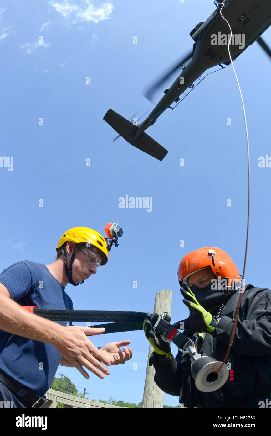 A South Carolina Helicopter Aquatic Rescue Team (SC-HART) member straps ...