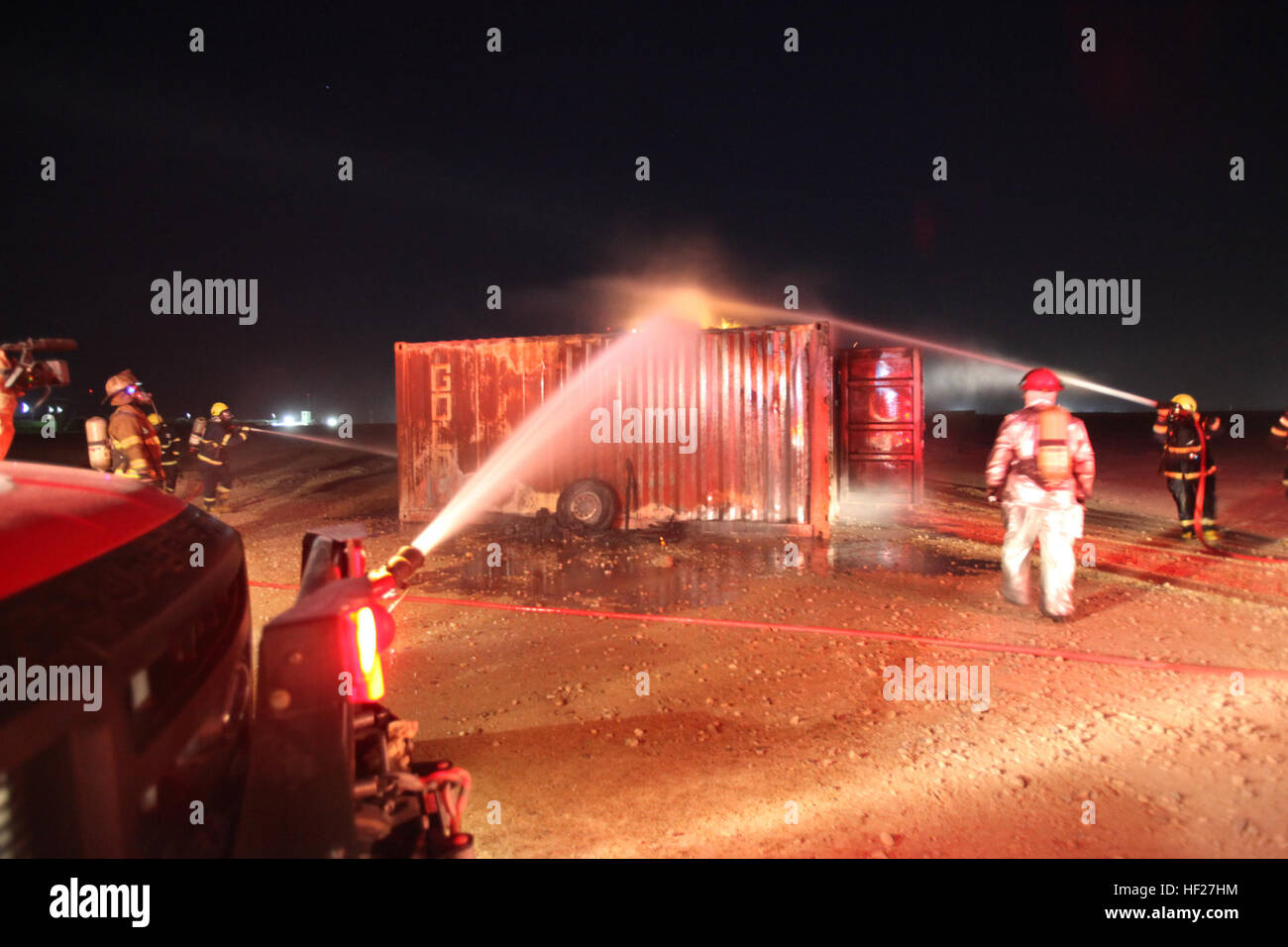 Afghan National Army soldiers work from multiple angles to extinguish a ...