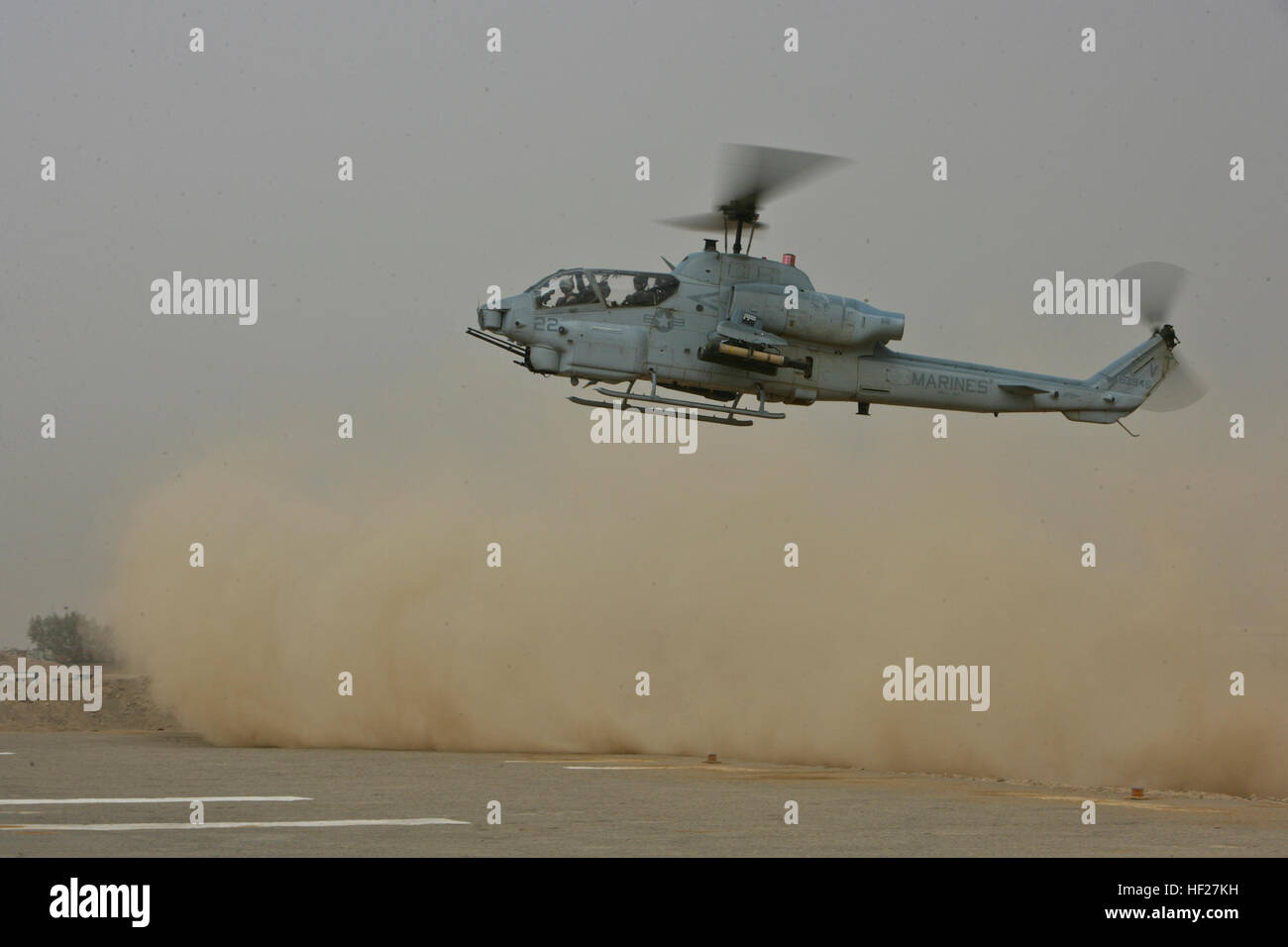 Dust builds up as an AH-1 Cobra Helicopter flown by Marines from Marine ...