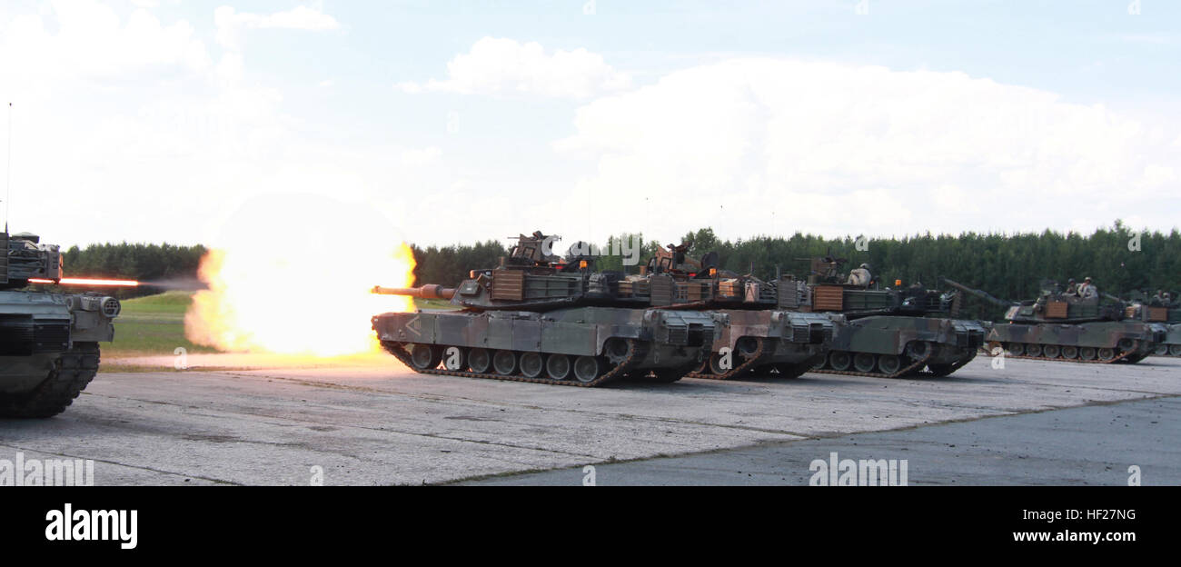 Muzzle flash erupts from the gun of an M1A2 Sep V2 Abrams tank assigned ...
